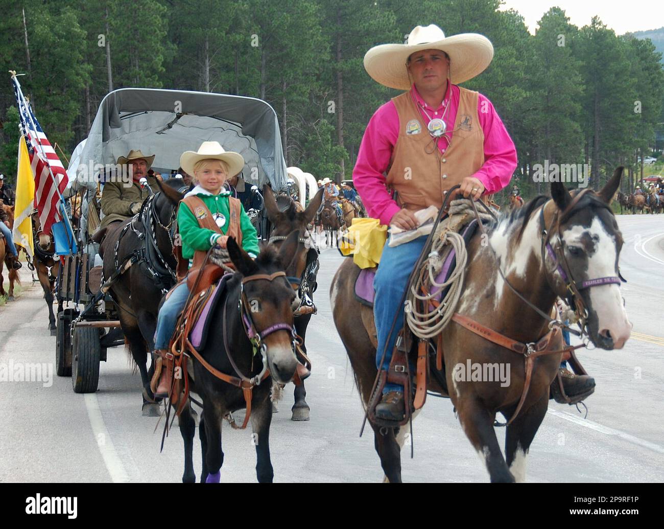 Bruce Kessler and his daughter, Kylie, 7, ride toward Deadwood, S.D ...