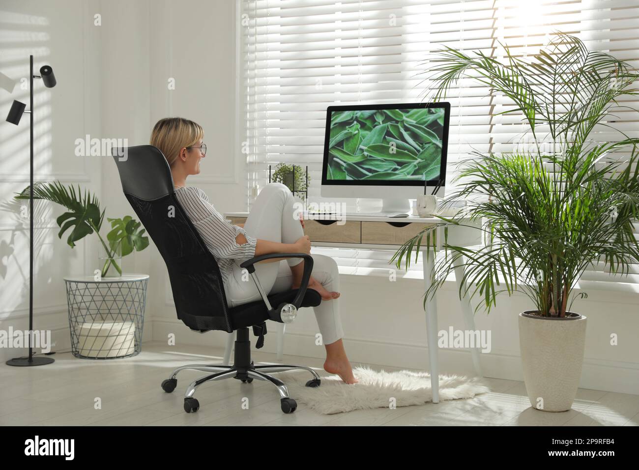 Woman resting on chair hi-res stock photography and images - Alamy