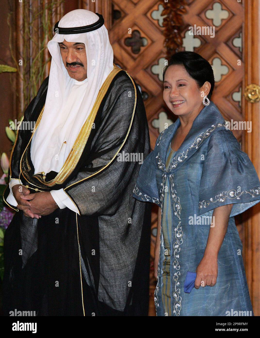 Philippines President Gloria Macapagal Arroyo, right, walks beside ...