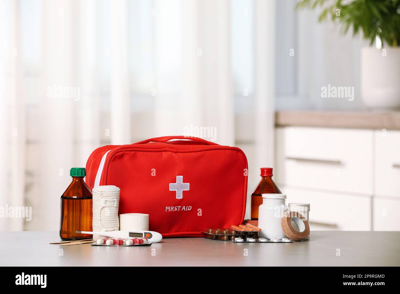 First aid kit on light grey table indoors Stock Photo - Alamy