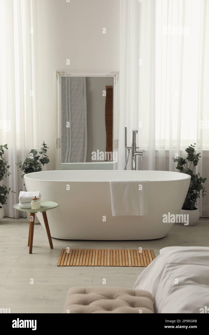 White tub and decor in light room. Interior design Stock Photo - Alamy