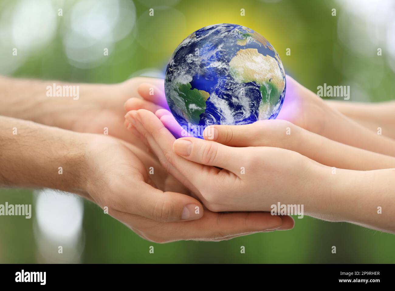 World in our hands. Closeup view of parents and kid holding digital ...