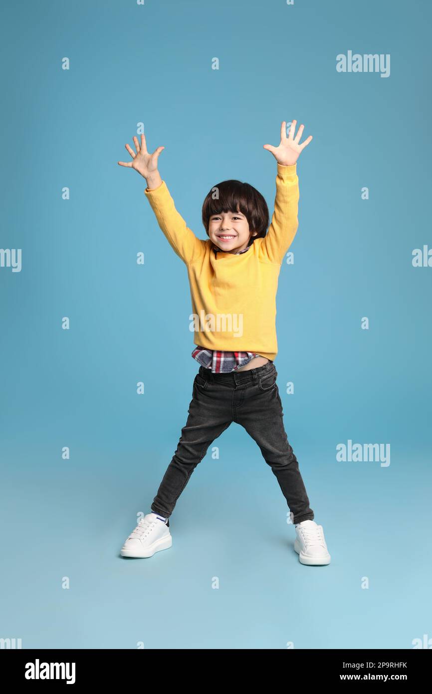 Full length portrait of cute little boy on light blue background Stock ...
