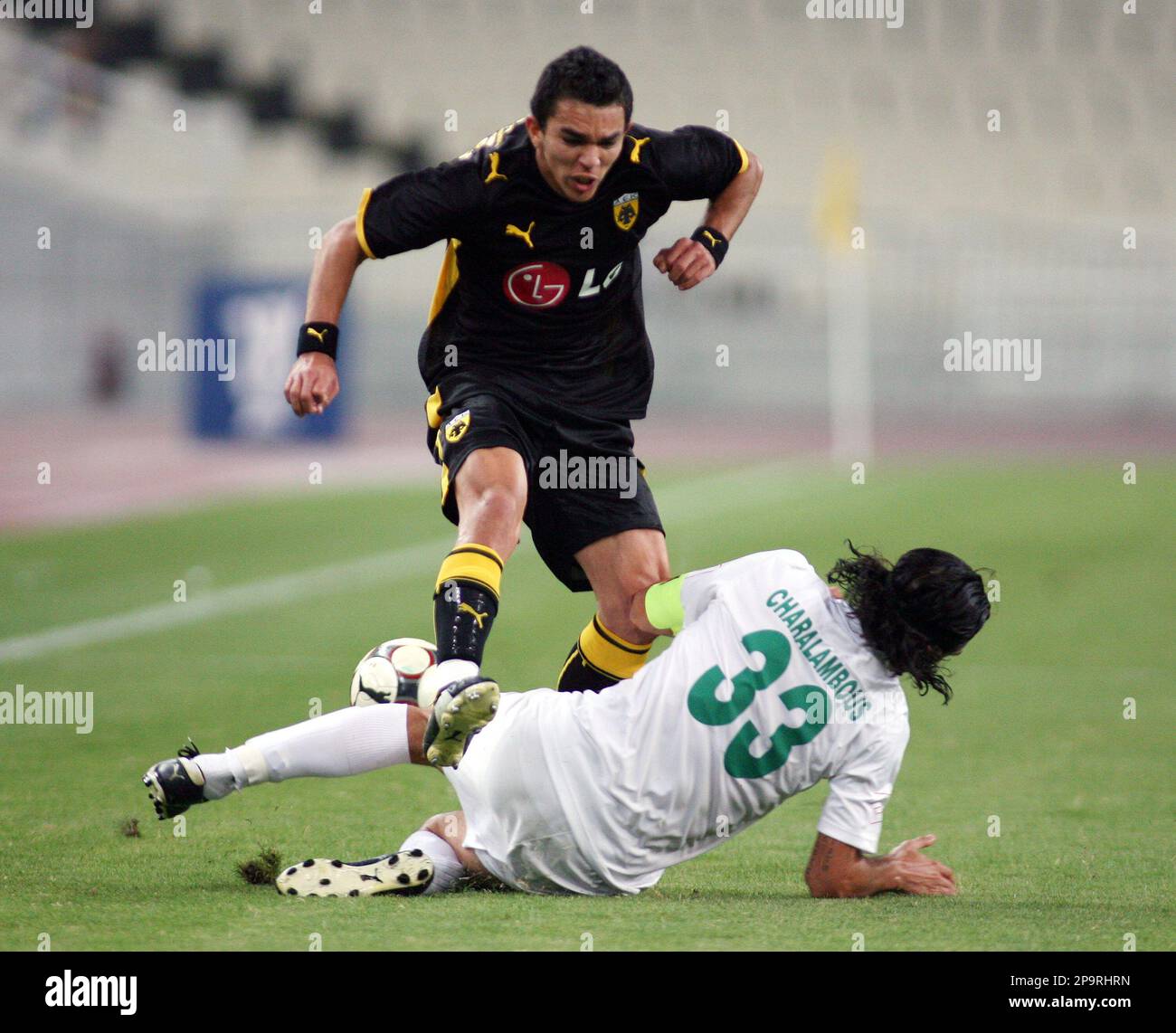 Edson Ramos Silva, top, of AEK Athens and Ilias Charalambous of Omonia ...