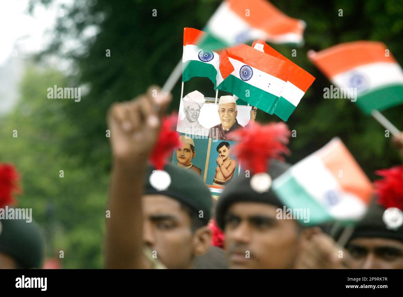 National Cadet Corps cadets hold high Indian flags and portraits of ...