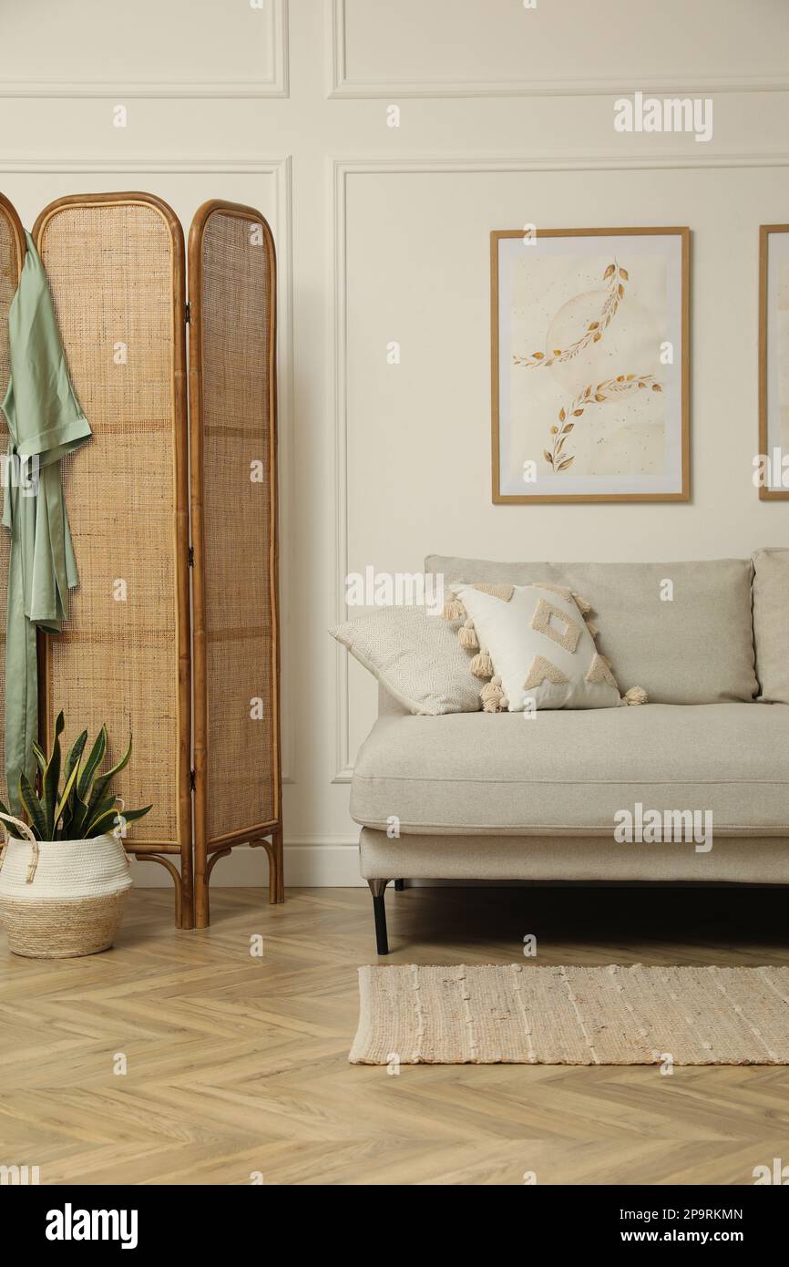 Stylish living room with folding screen and sofa. Interior design Stock ...