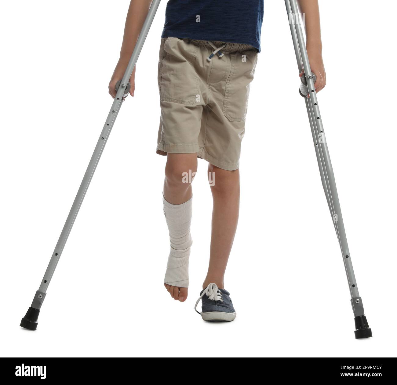 Boy with injured leg using crutches on white background, closeup Stock ...
