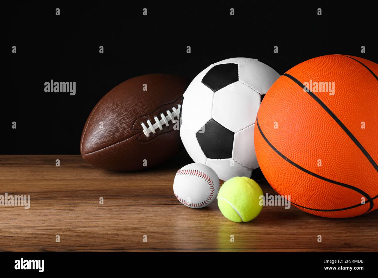 Set of different sport balls on wooden surface Stock Photo - Alamy