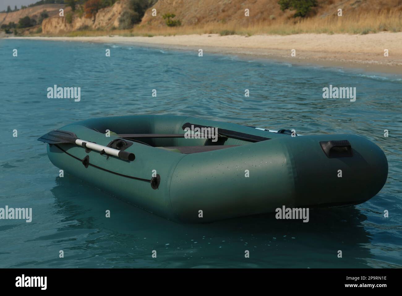 Inflatable rubber fishing boat floating in sea near coast Stock Photo ...