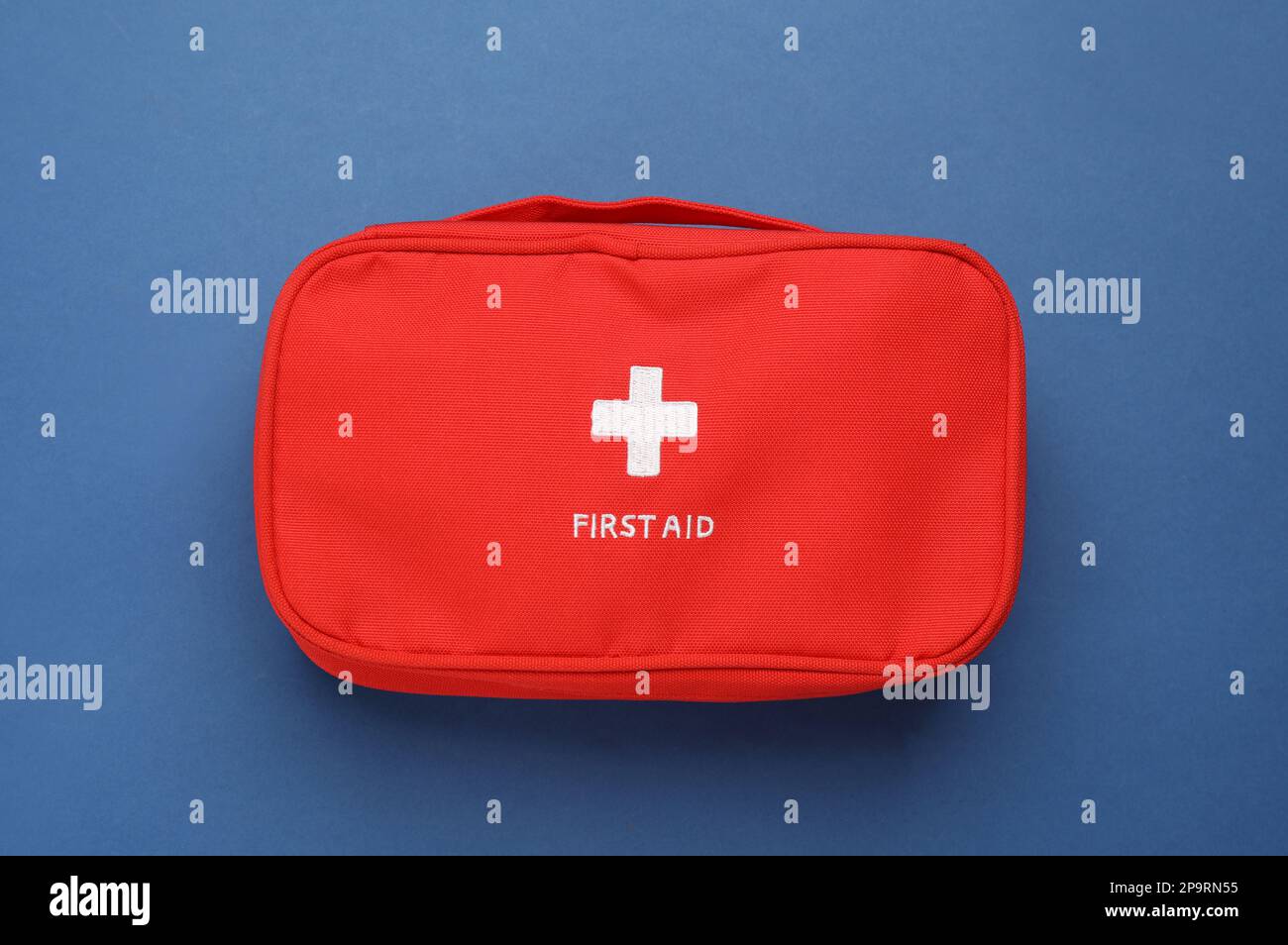 First aid kit bag on blue background, top view Stock Photo - Alamy