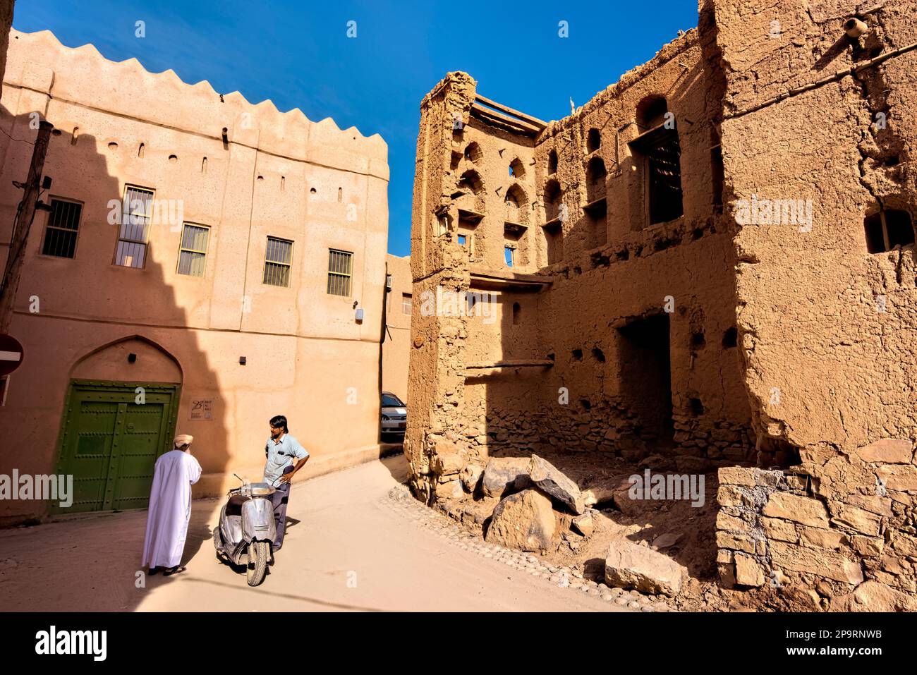 Falling down mud-brick ruins of the old village in Al Hamra, Oman Stock ...
