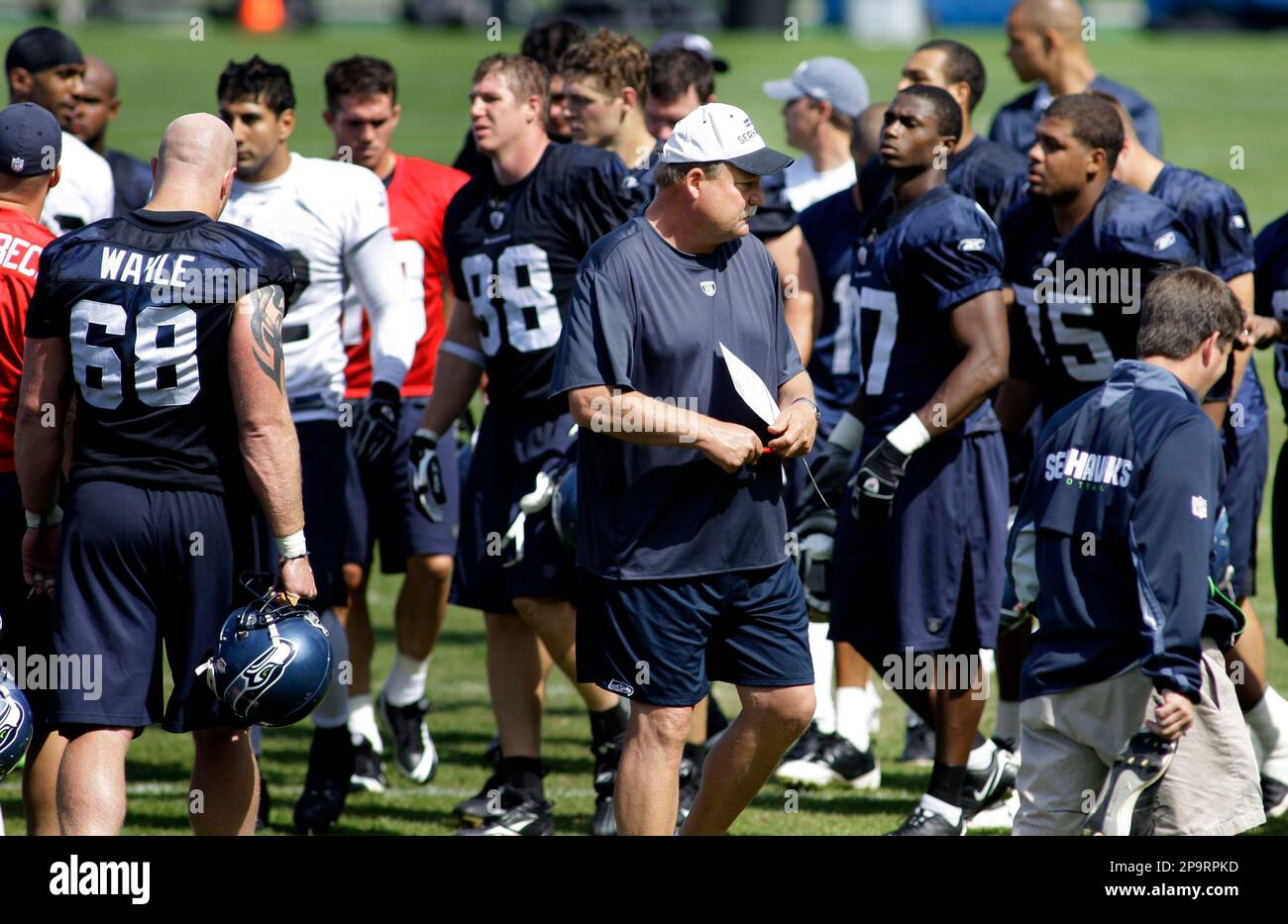 Seattle Seahawks coach Mike Holmgren, center, walks away from the ...