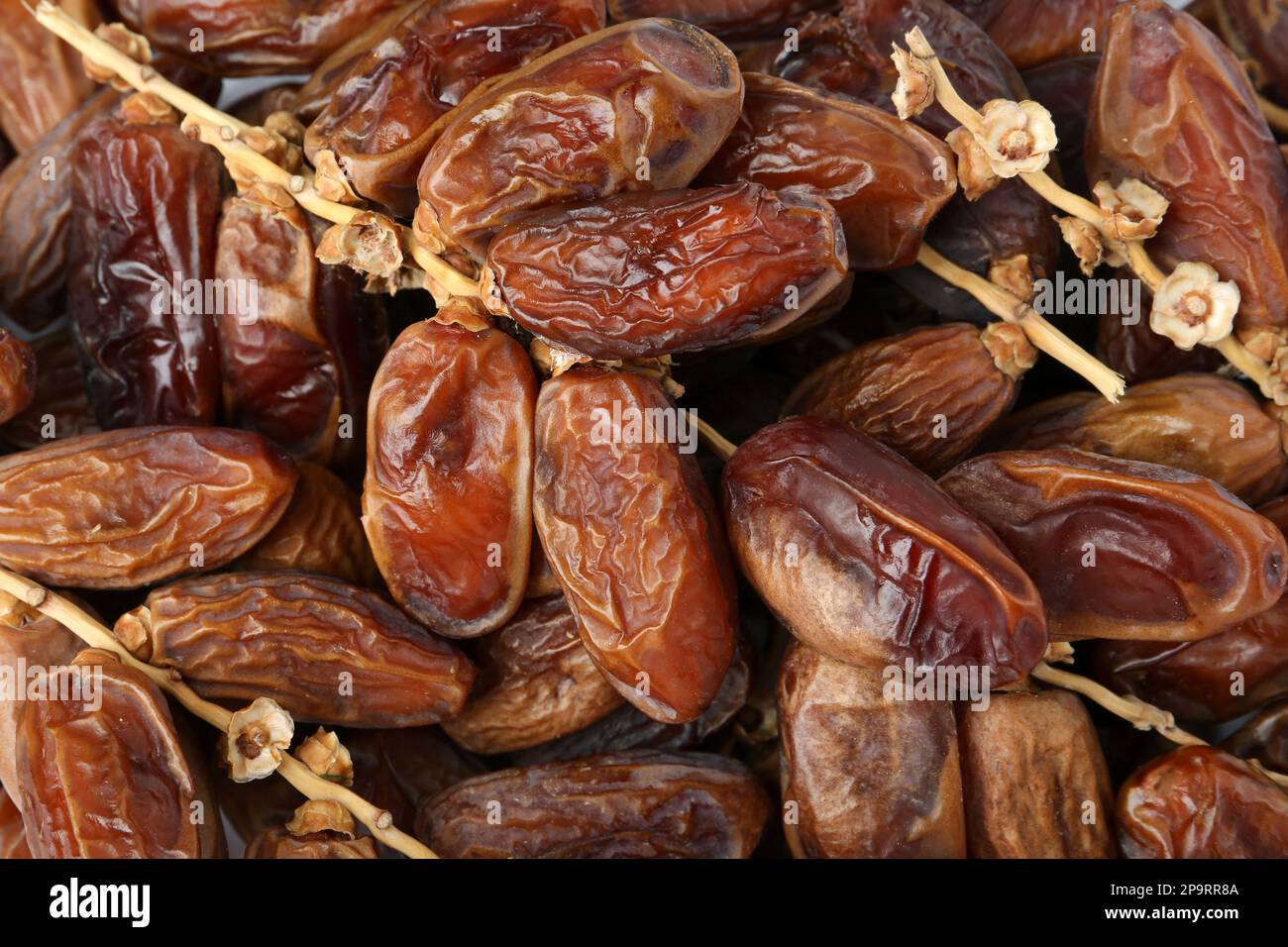 Sweet dried dates on branches as background, top view. Healthy snack ...
