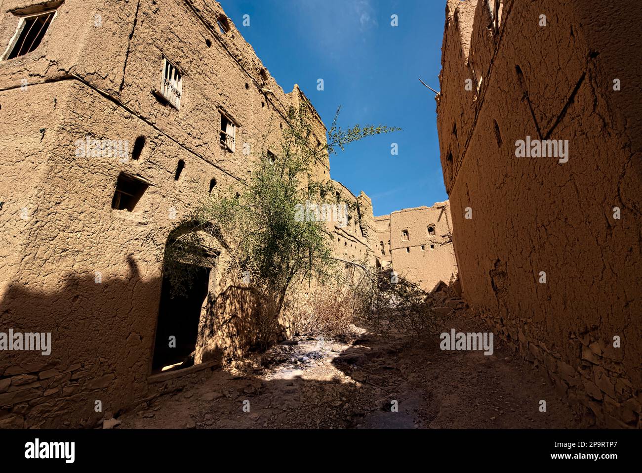 Falling down mud-brick ruins of the old village in Al Hamra, Oman Stock ...