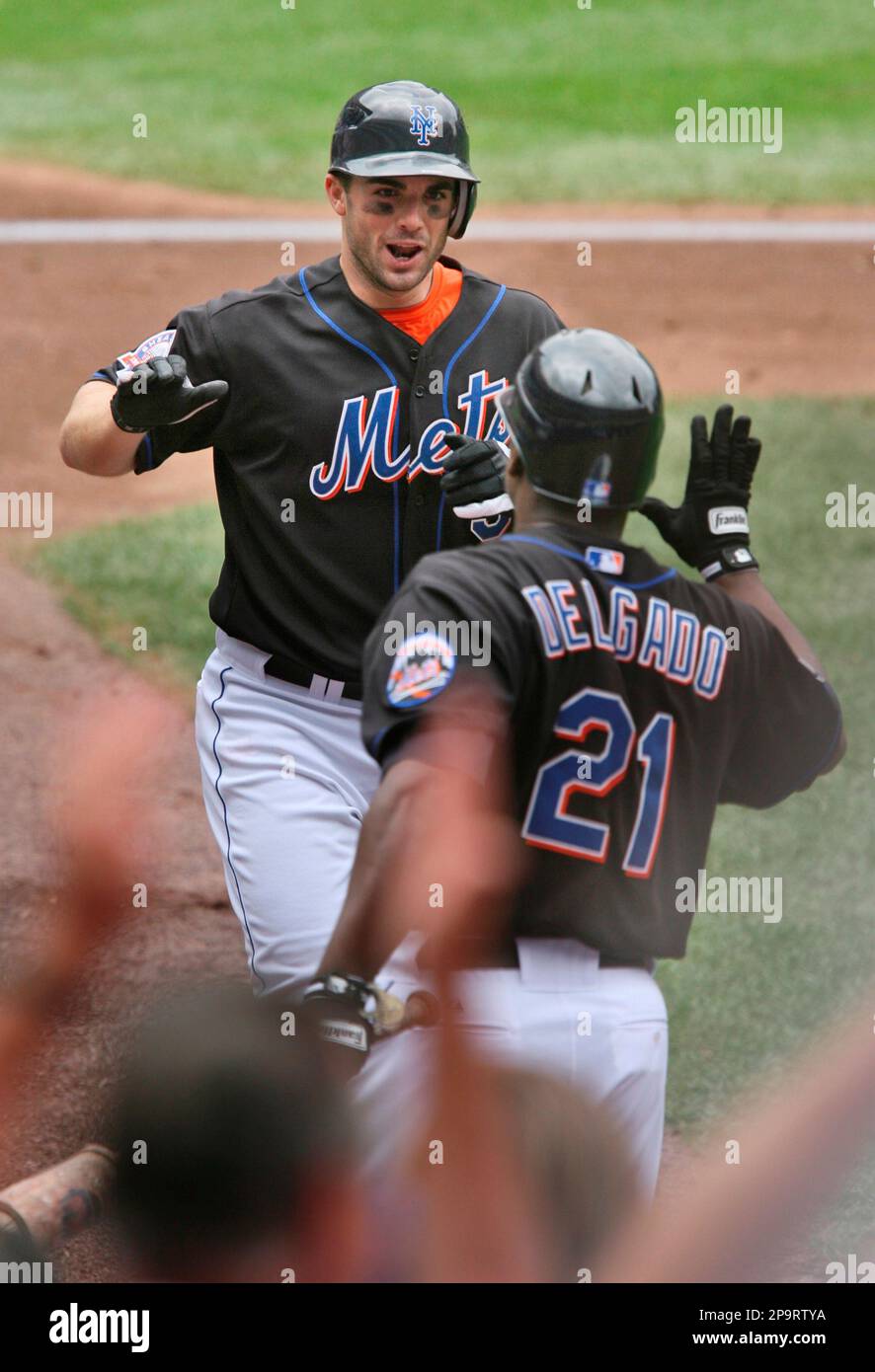 New York Mets' David Wright, left, is greeted by Carlos Delgado after ...