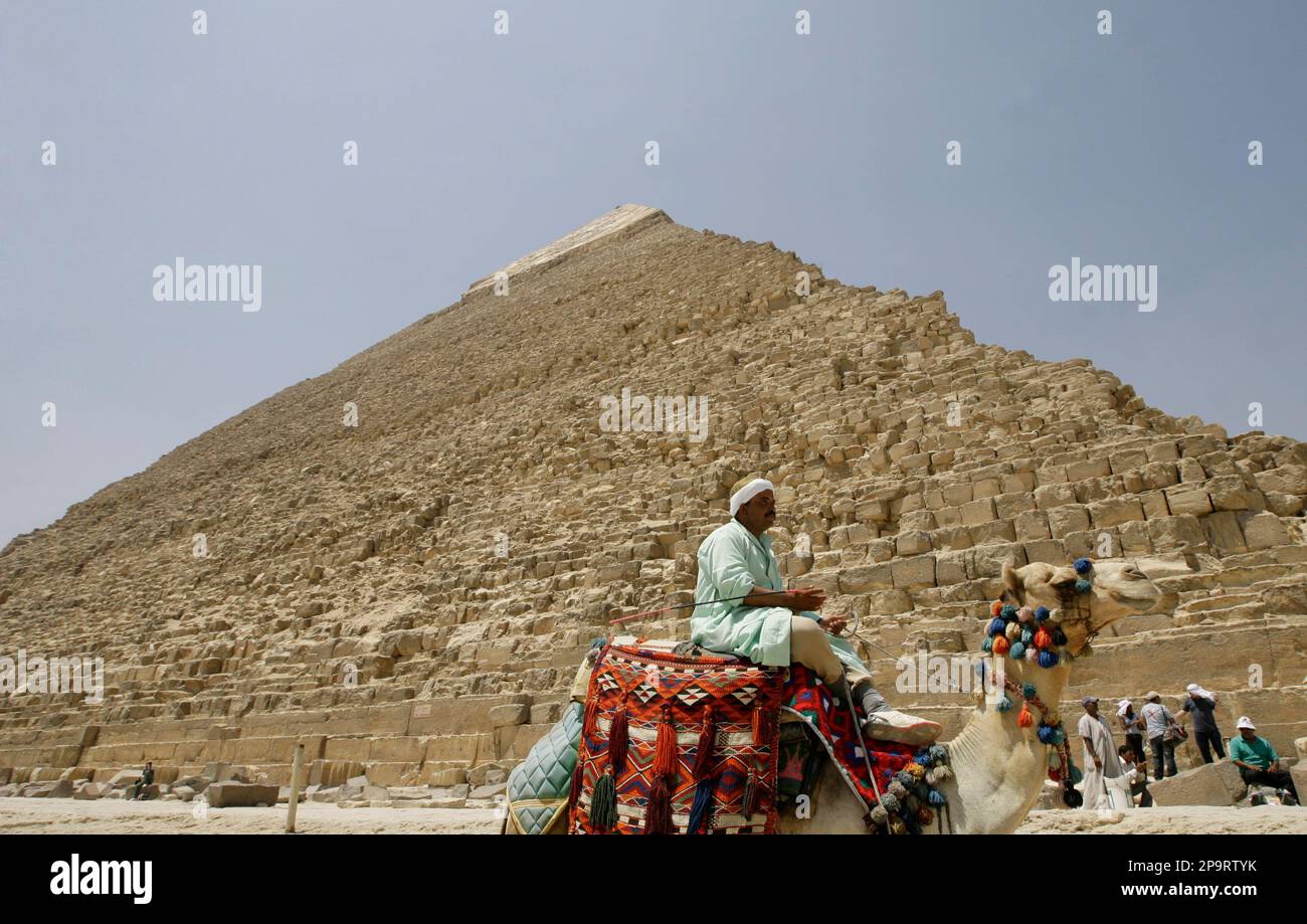 An Egyptian camel rider waits for customers at the site of the ancient ...
