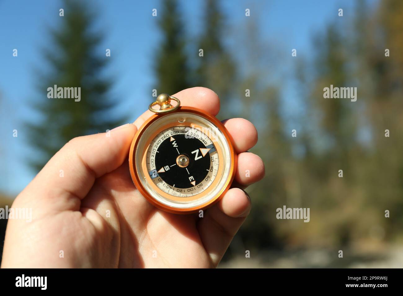 Man using compass for navigation during journey outdoors, closeup Stock ...