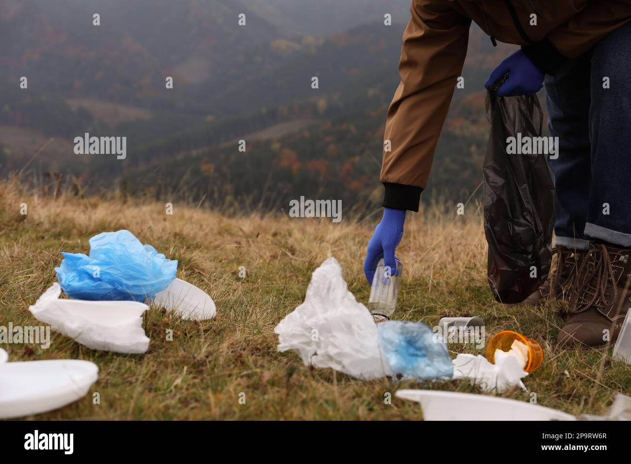 Woman with trash bag collecting garbage in nature, closeup Stock Photo ...
