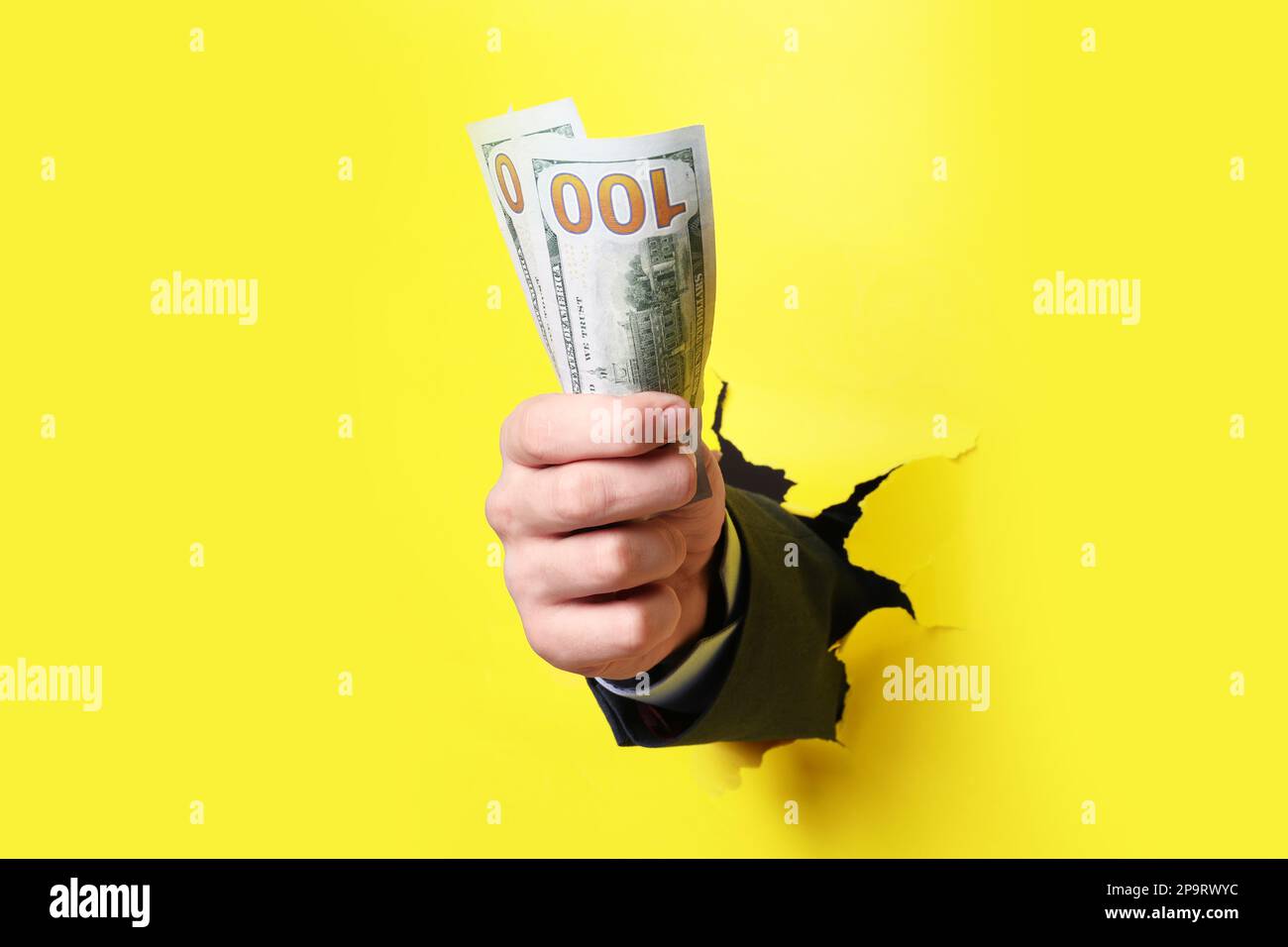 Hand breaking through paper holding hi-res stock photography and images ...