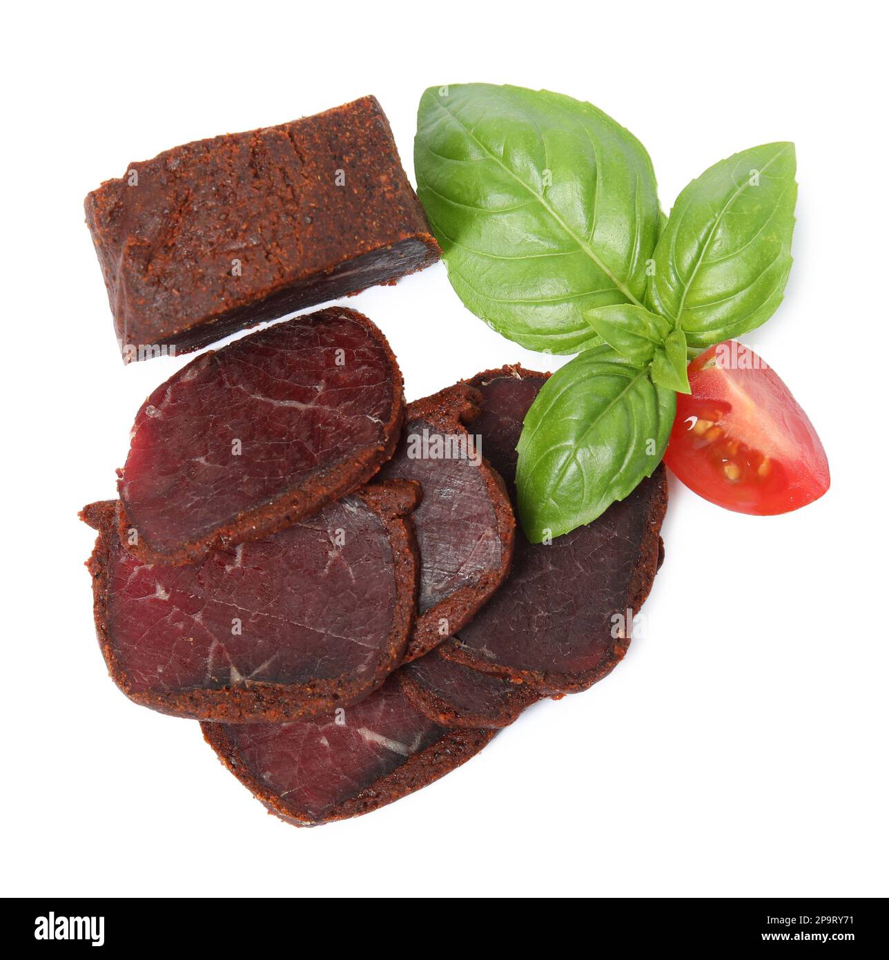 Delicious dry-cured beef basturma with basil and tomato on white ...
