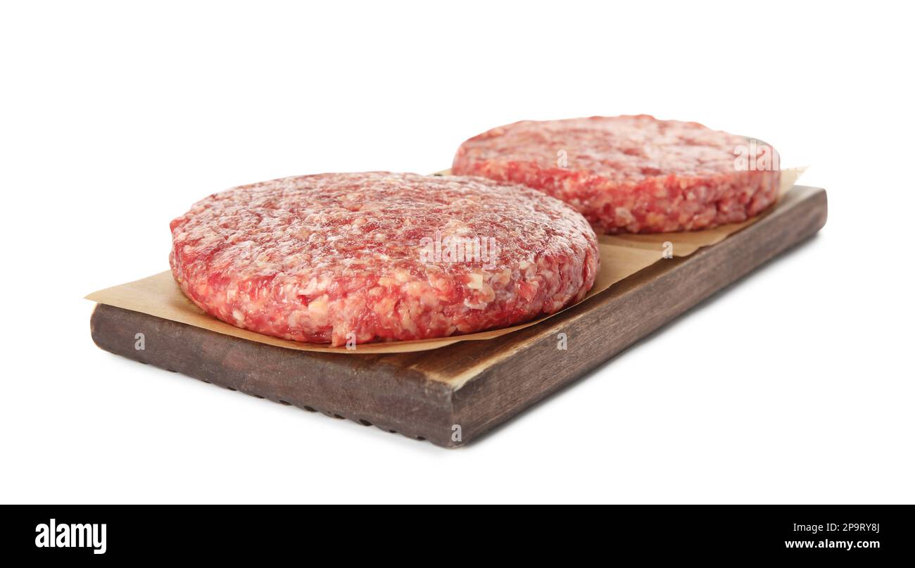 Raw hamburger patties and wooden board on white background Stock Photo ...