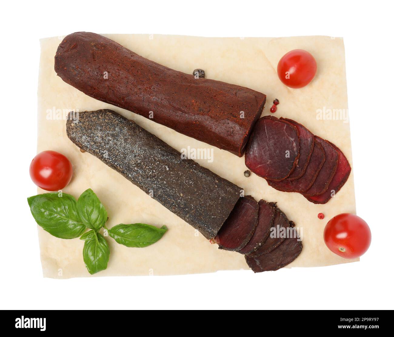Delicious dry-cured beef basturma with basil and tomatoes on white ...