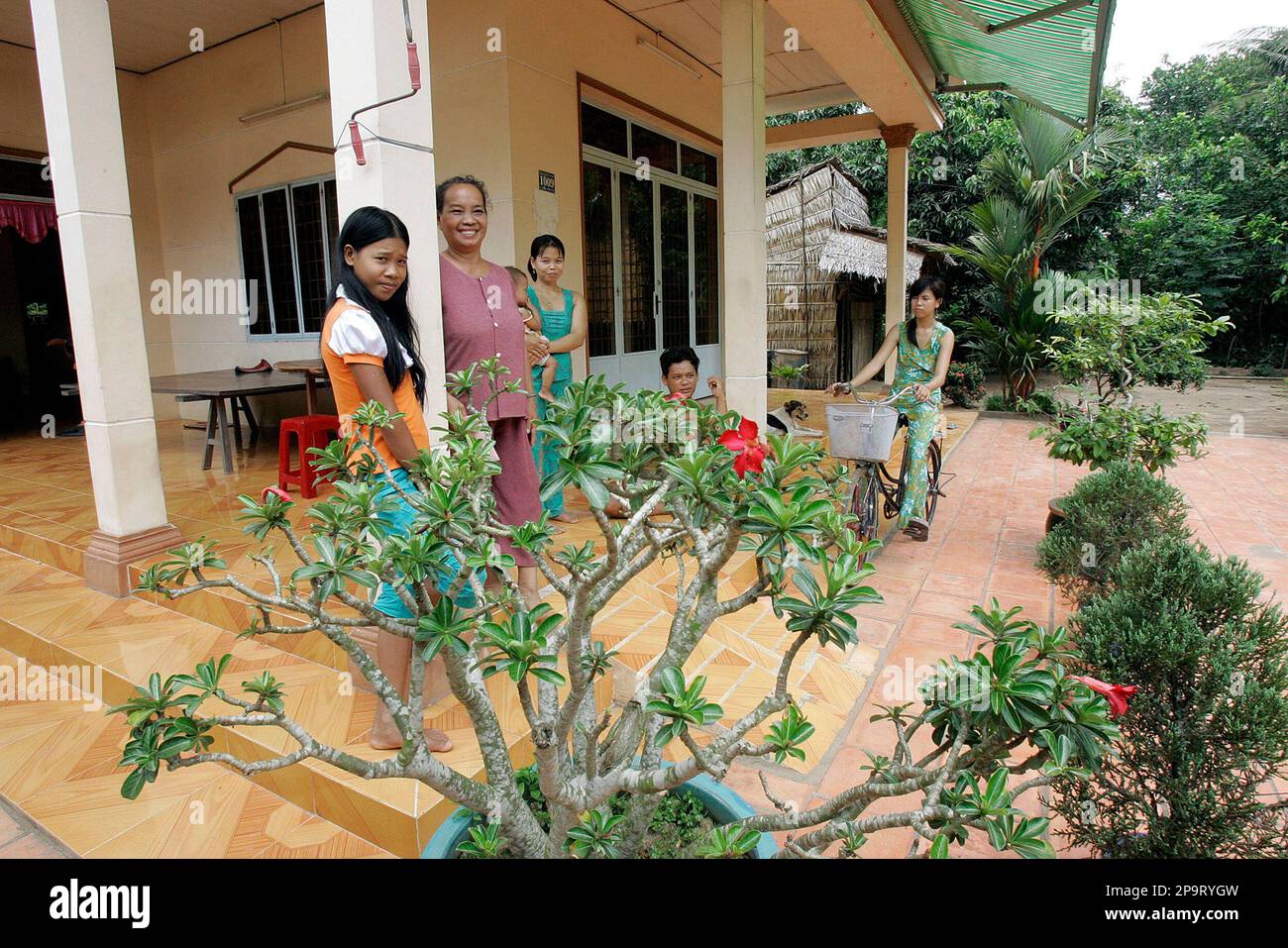 Tran Thi Sach, 59, second left, whose two daughters married with ...