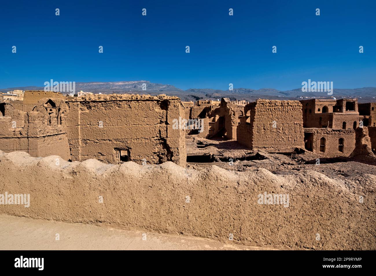 Falling down mud-brick ruins of the old village in Al Hamra, Oman Stock ...
