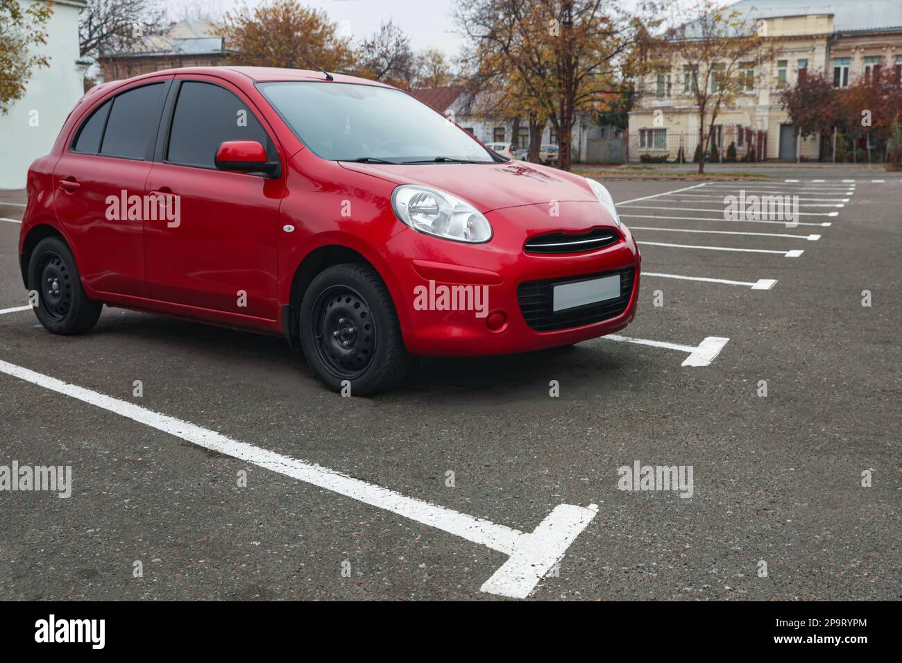 Modern red car on parking lot outdoors Stock Photo - Alamy