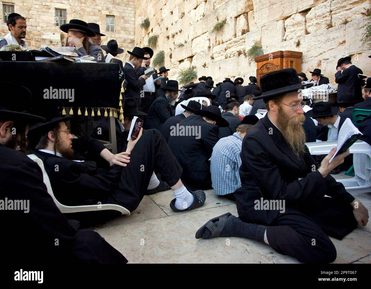 Ultra-orthodox Jewish men pray as they gather for the mourning ritual ...