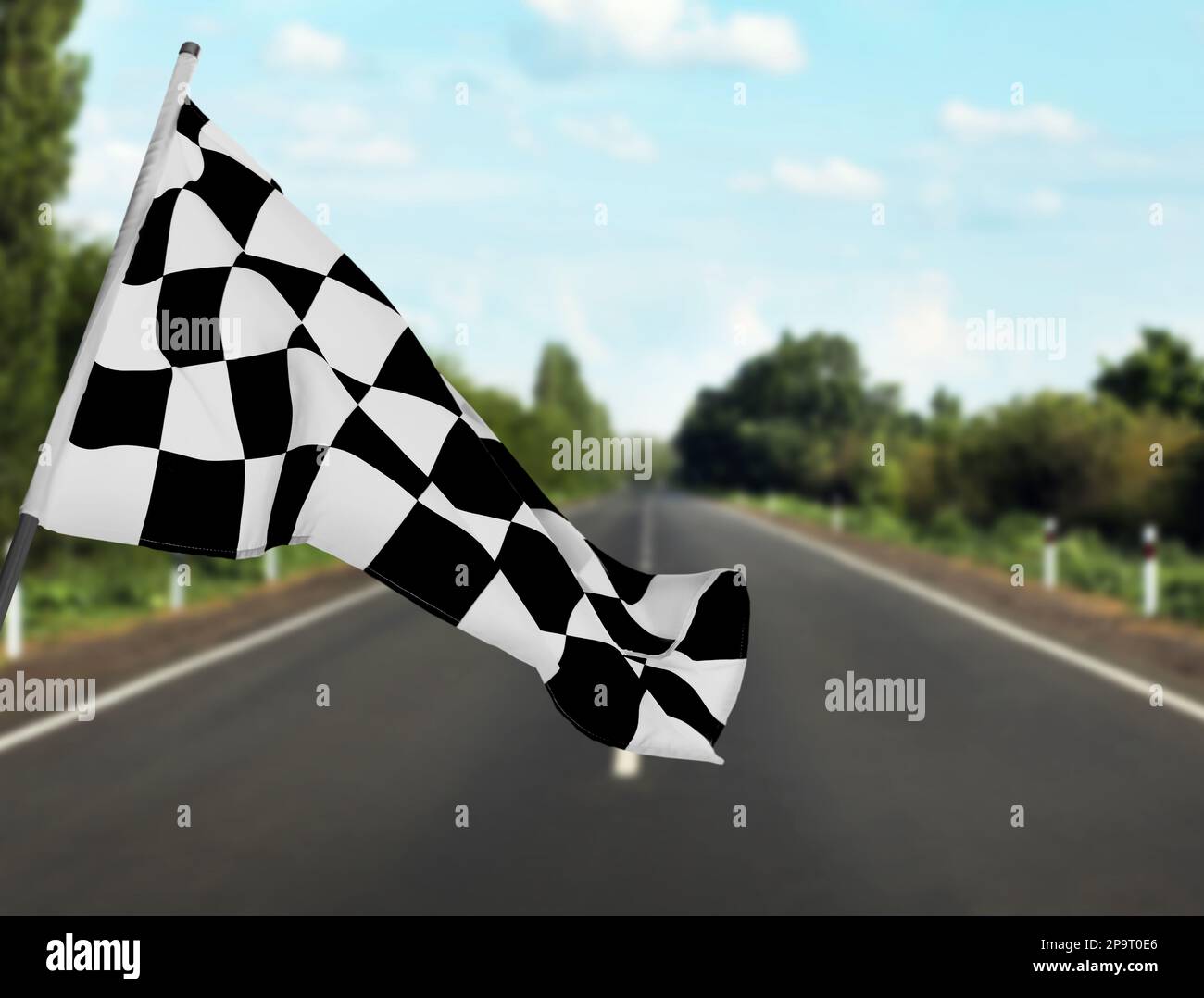 Checkered racing finish flag and asphalt road outdoors Stock Photo - Alamy