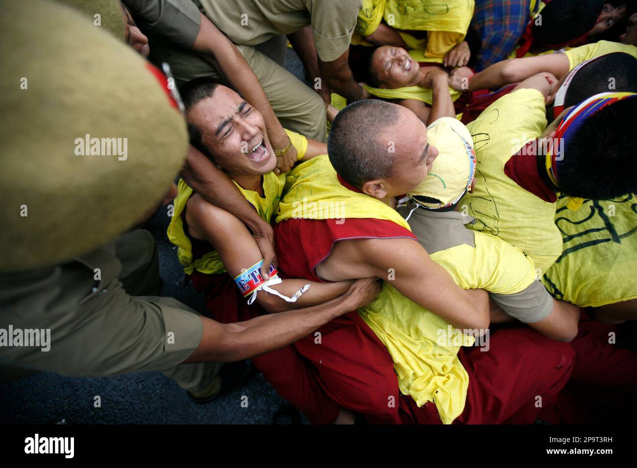Tibetan monks are detained by Indian policemen outside the Chinese Embassy in New Delhi, India ...
