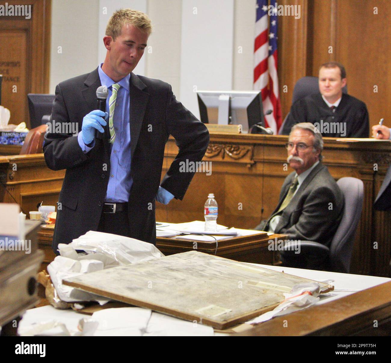 Denver Police Detective Shawn O'Toole shows recovered evidence to the ...