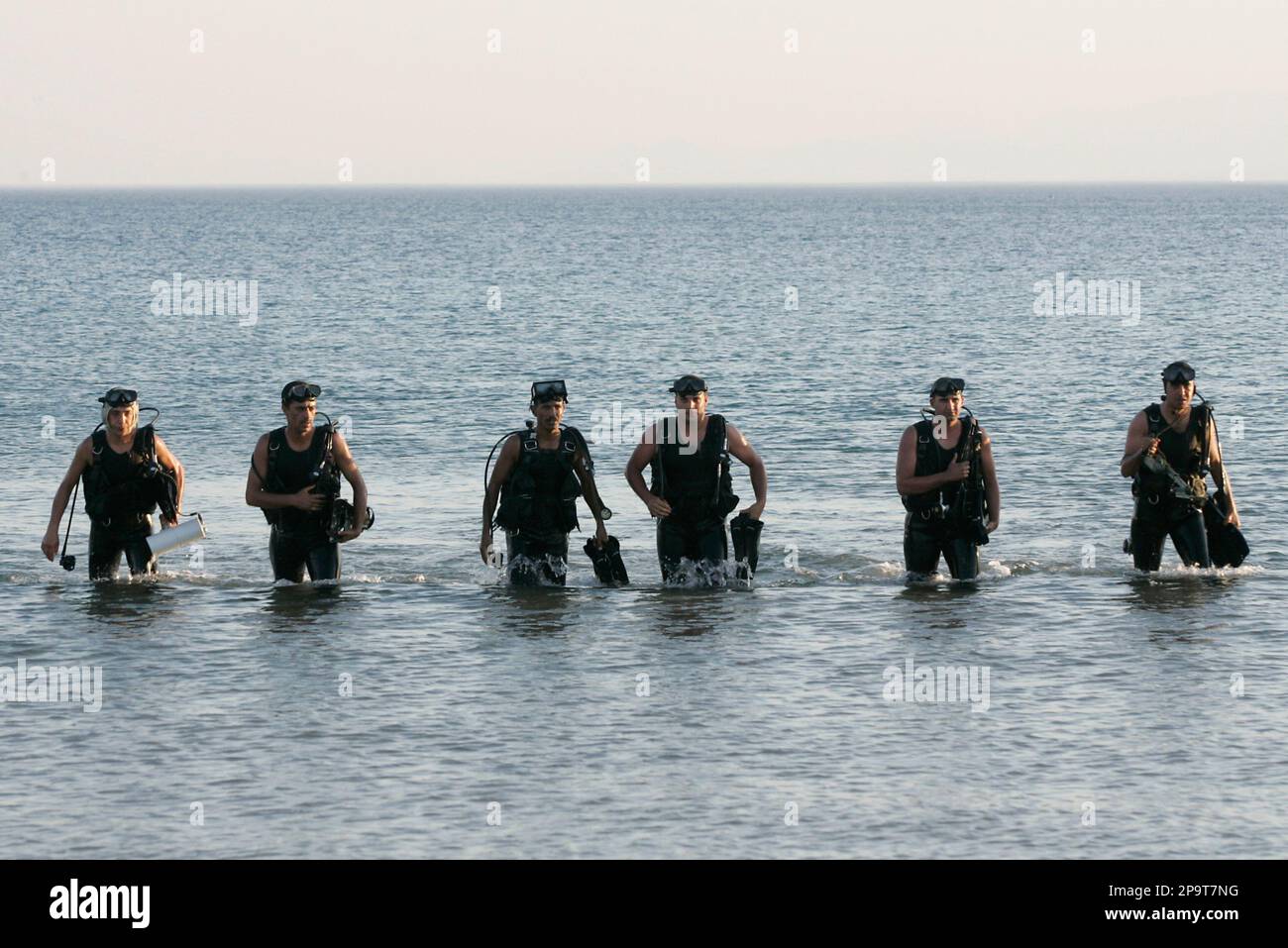 Jordanian diving de-mining team walks out of sea during a celebration ...