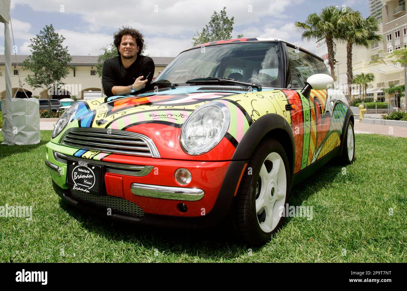 Brazilian artist Romero Britto poses next to a car painted by him in ...