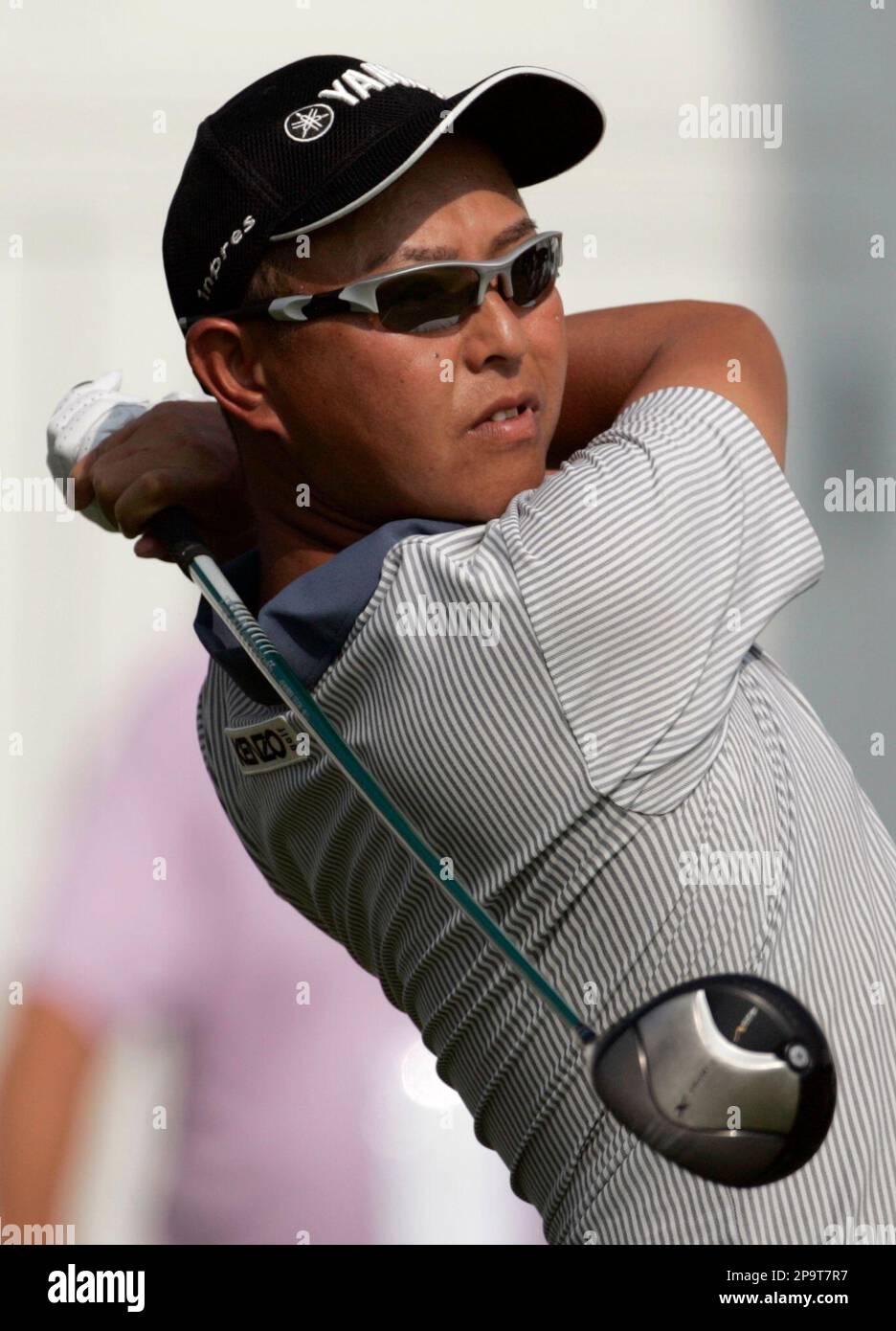 Toru Taniguchi, of Japan, drives from the first tee during practice for ...