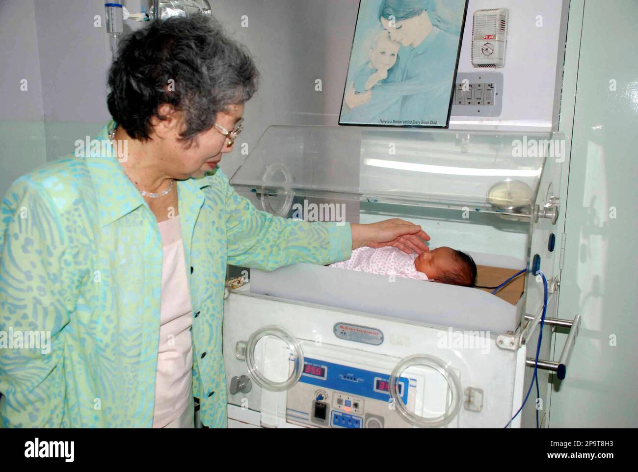 Emiko Yamada looks at her 11-day-old granddaughter Manji Yamada at a ...