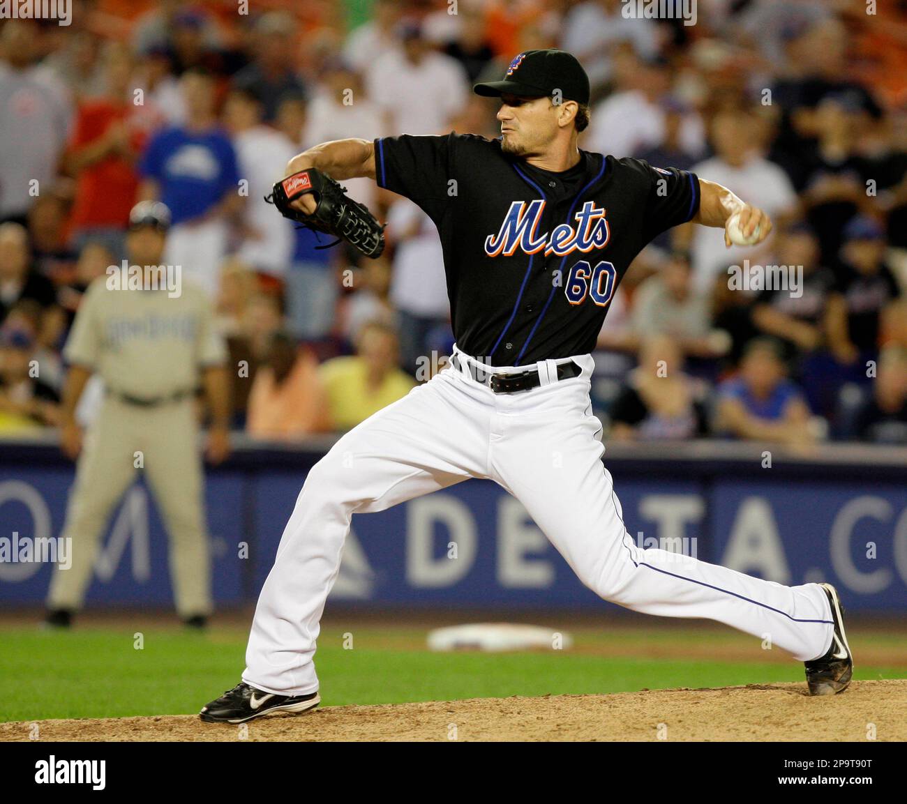 New York Mets reliever Scott Schoeneweis winds up for the only pitch he ...