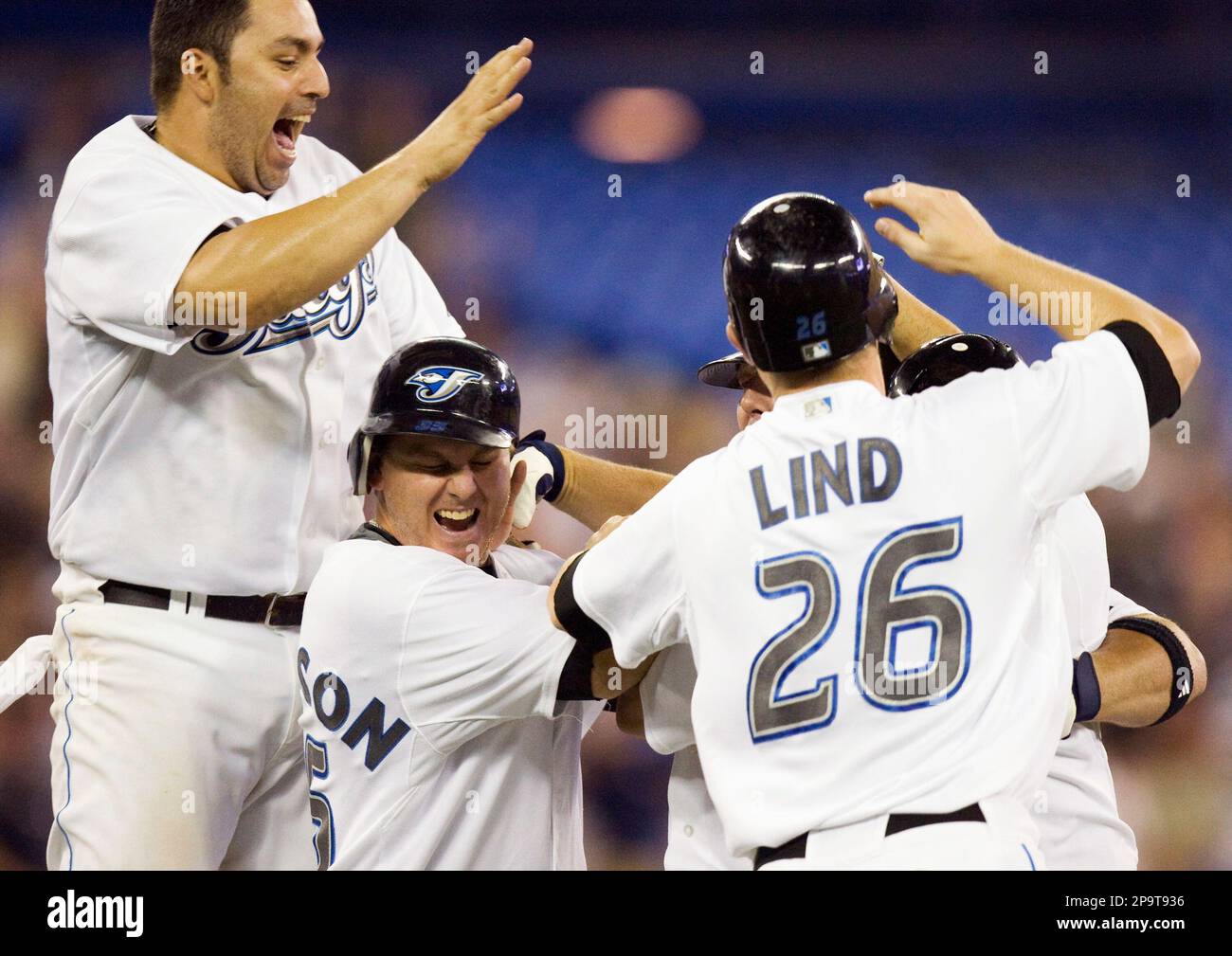Toronto Blue Jays Kevin Mench, back, is mobbed by Rod Barajas, left ...