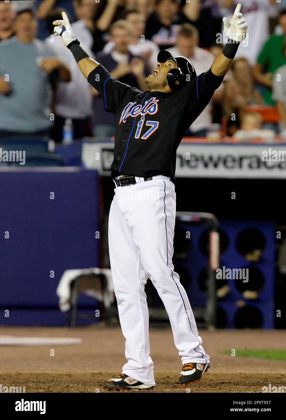New York Mets' Fernando Tatis points skyward after hitting a sixth ...