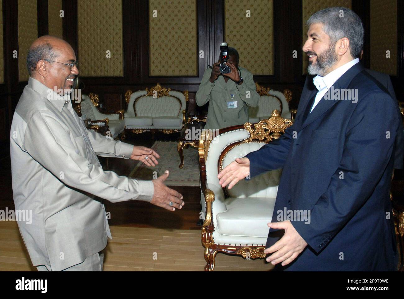 Sudanese President Omar El-Bashir, left receives Hamas leader Khaled ...