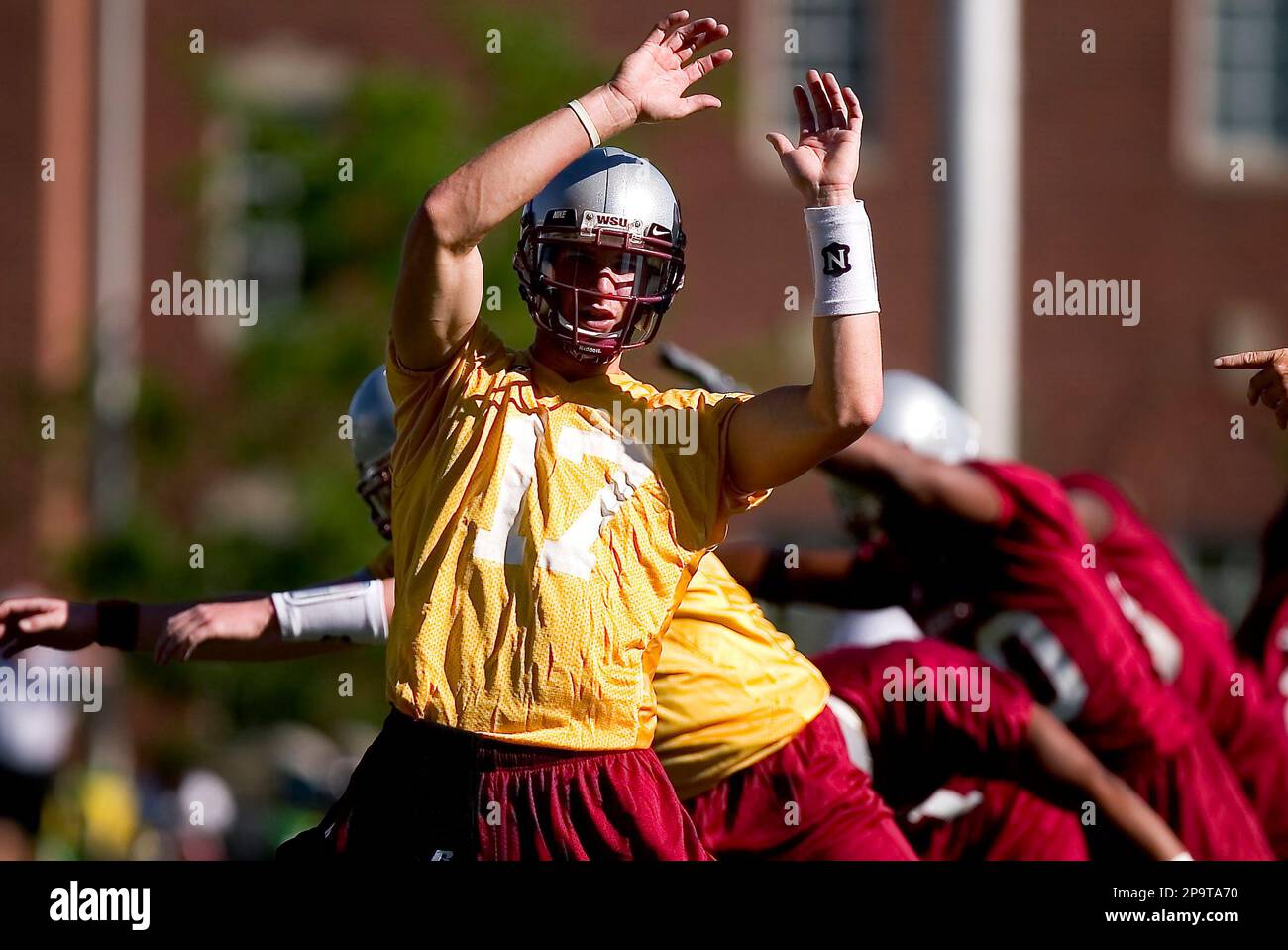 Washington State quarterback Gary Rogers stretches at the start of the ...