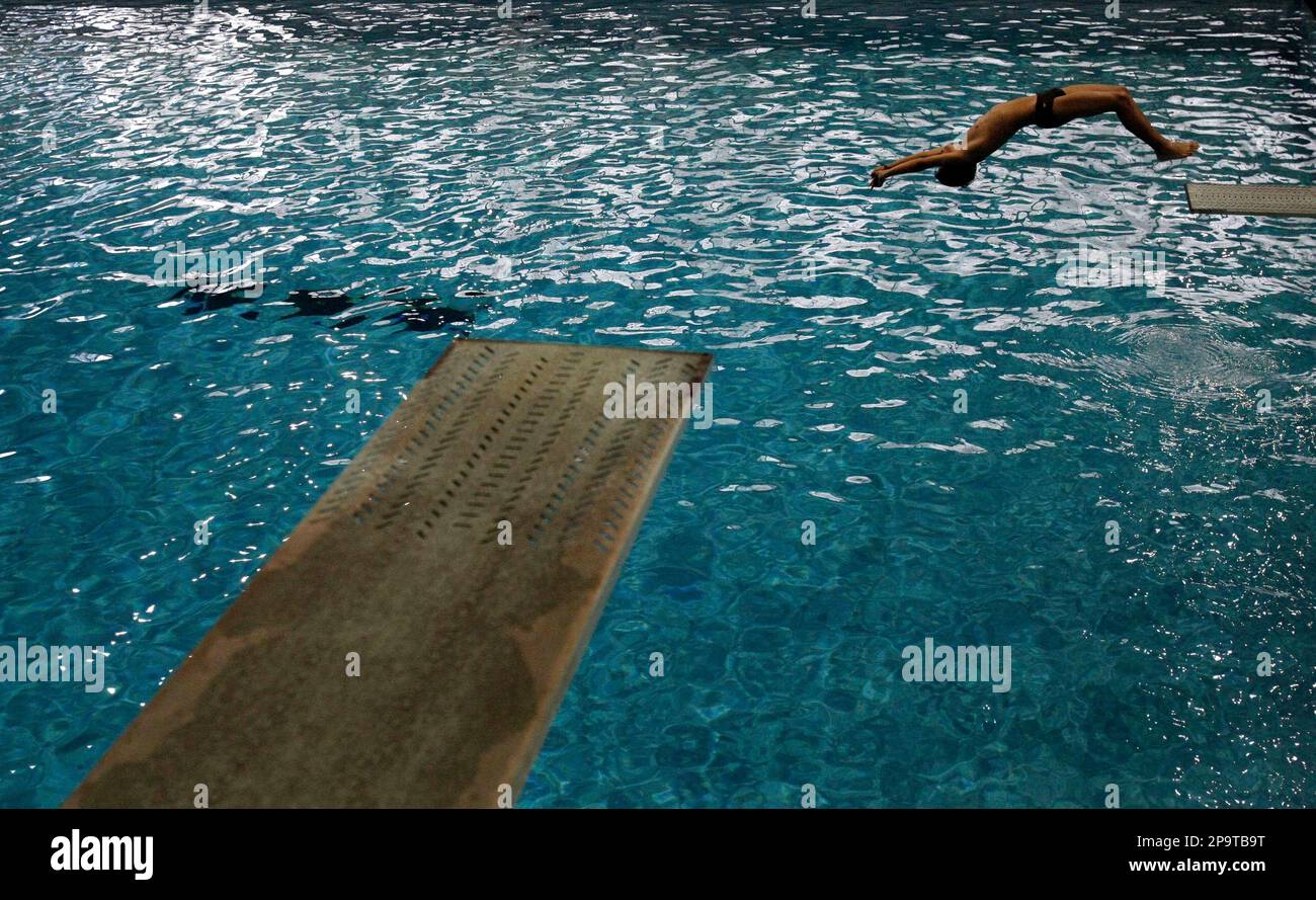 A diver jumps into the pool built for the 1968 Olympics in Mexico City ...