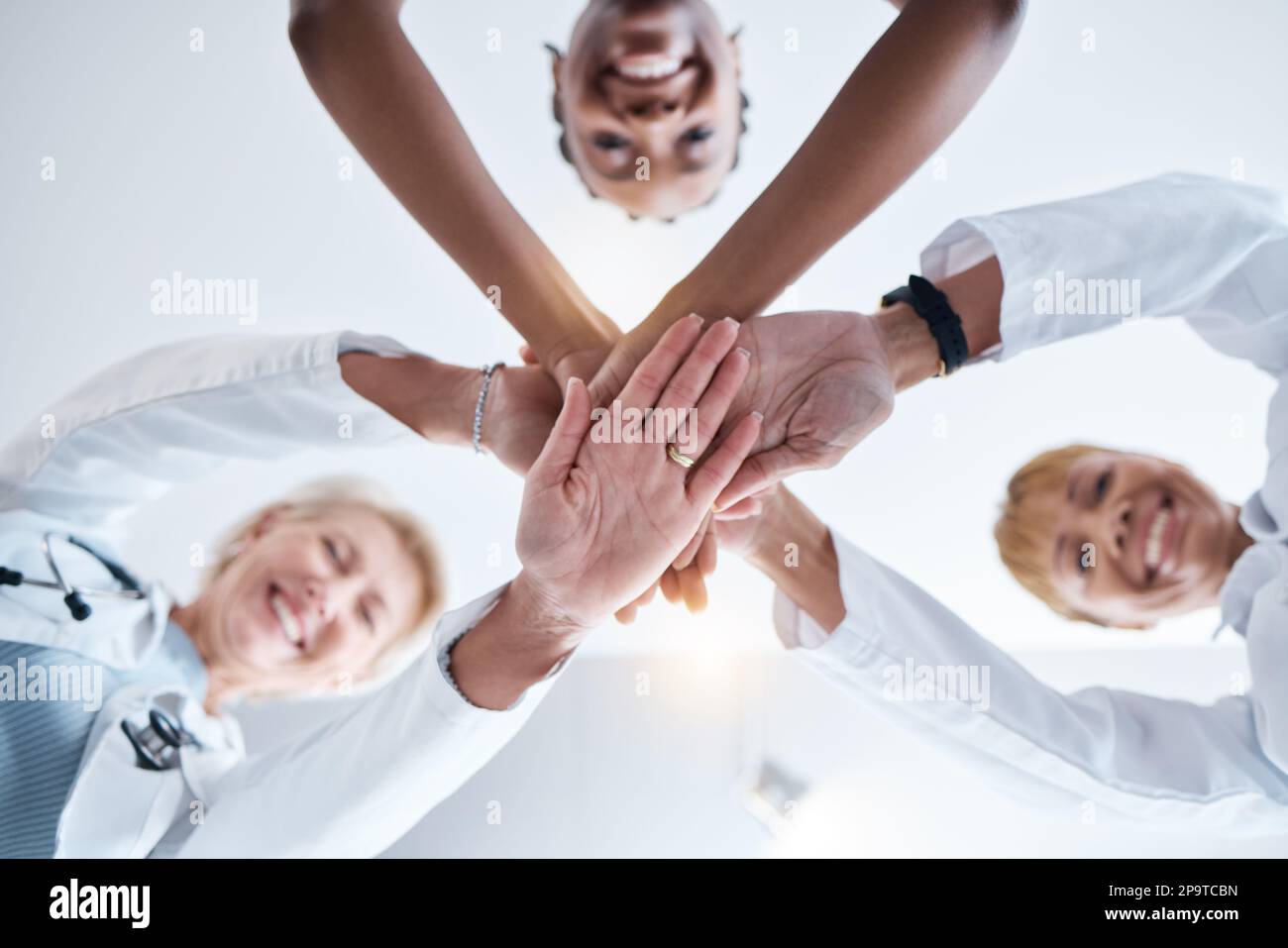 Doctor, group and stack hands in circle for teamwork portrait ...
