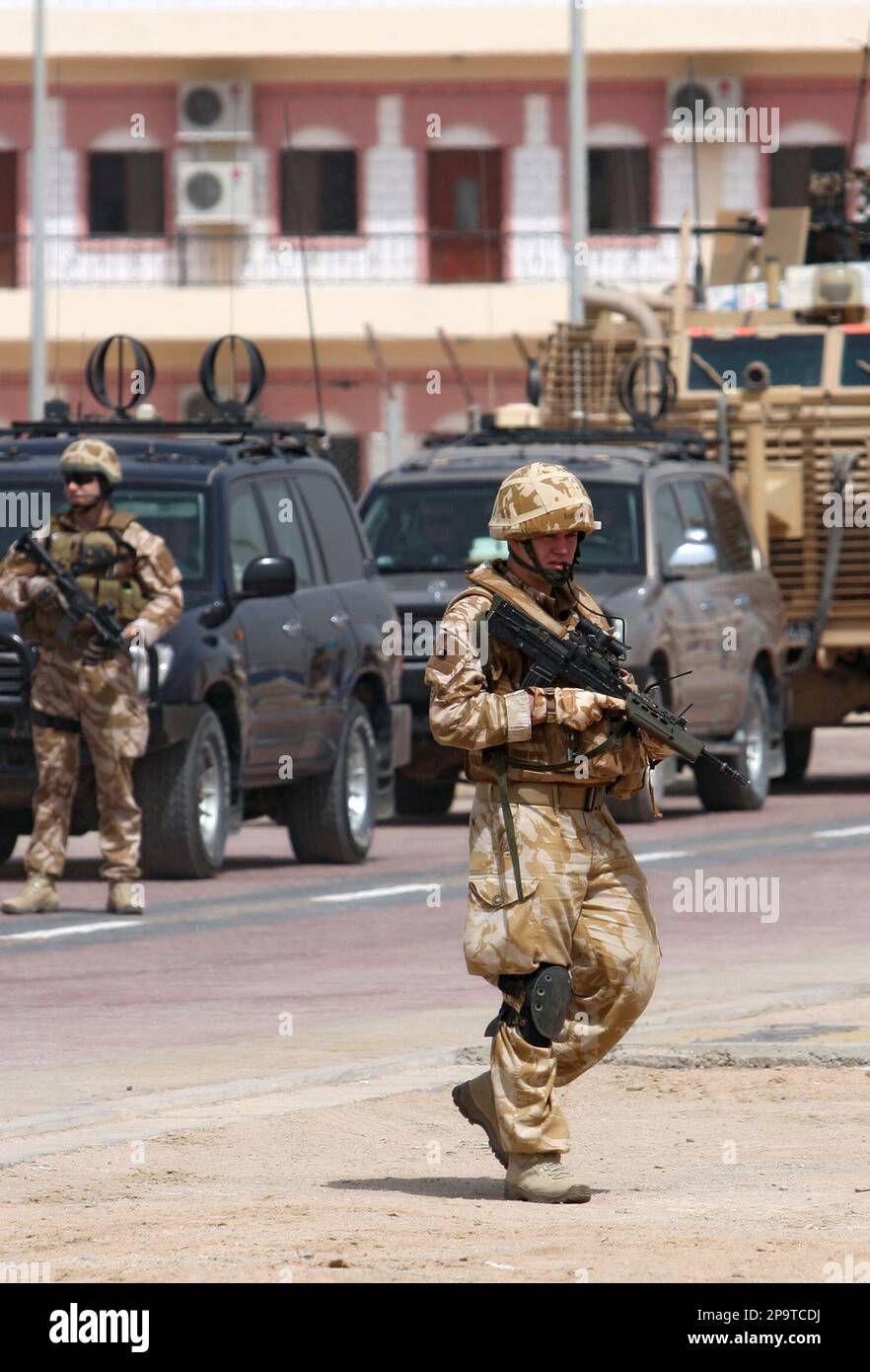 British army troops provide some security during a ceremony to open a ...