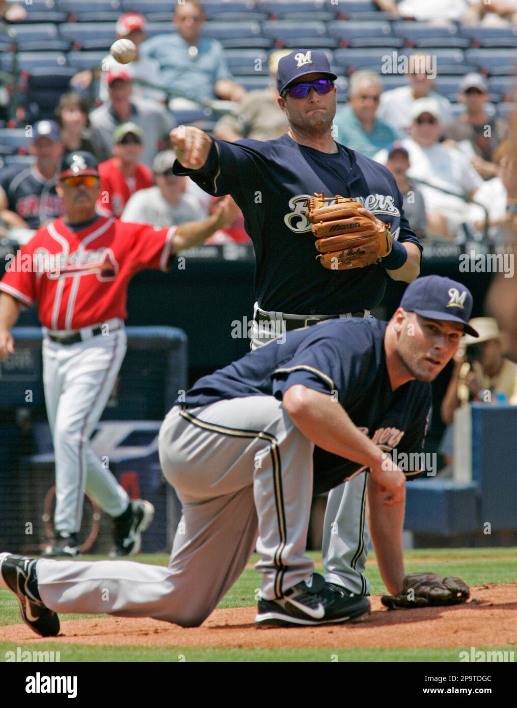 Milwaukee Brewers third baseman Russell Branyan, top, throws a bunted ...
