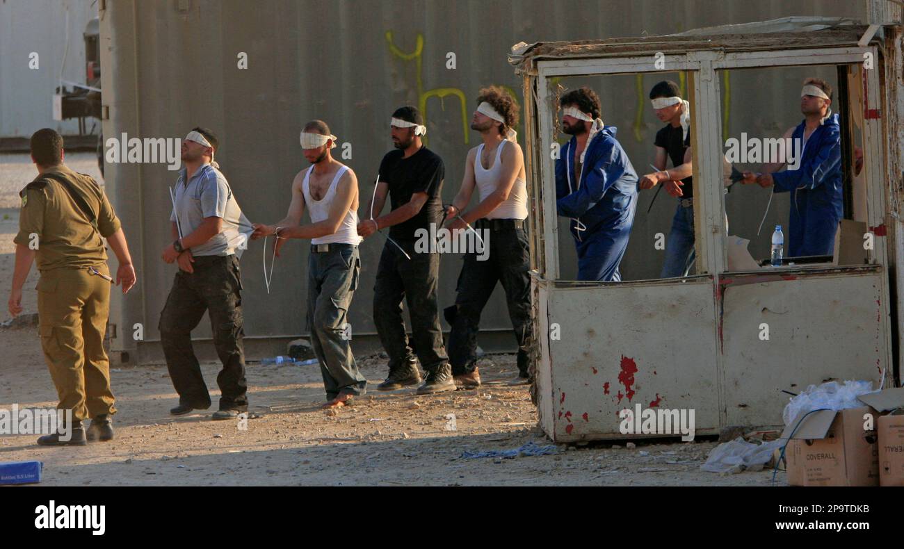 Israeli Soldiers Escort Blindfolded And Handcuffed Palestinians