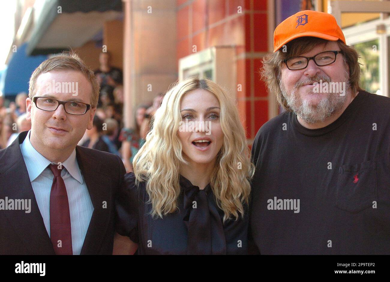 Director Nathan Rissman, left, Madonna, center, and Michael Moore pose ...
