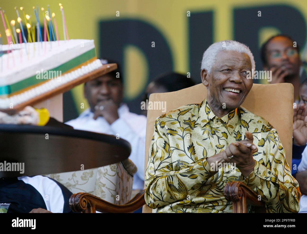 Former South African President Nelson Mandela smiles before cutting a ...
