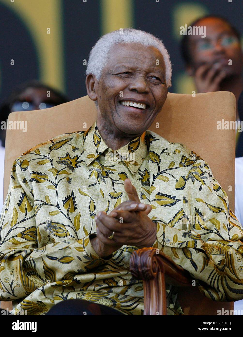 Former South African President Nelson Mandela smiles before cutting a ...